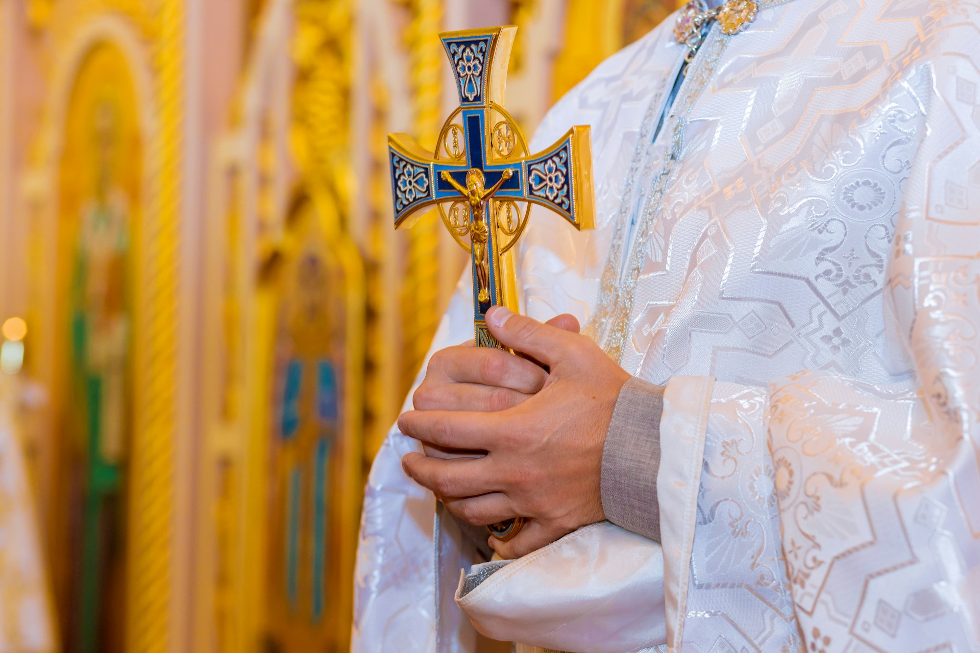 The holy orthodox father priest holds with a cross in his hands ...